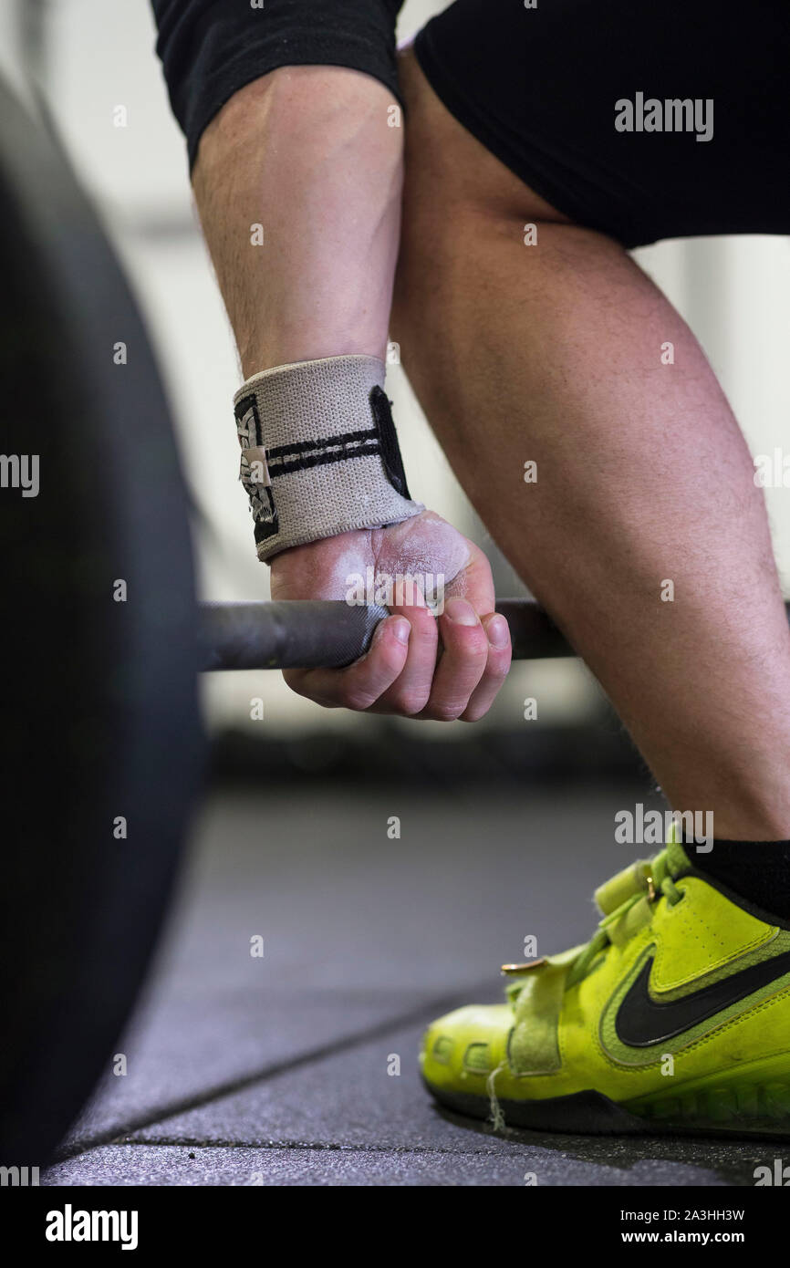 A young white male athlete performs various lifts and bodyweight ...