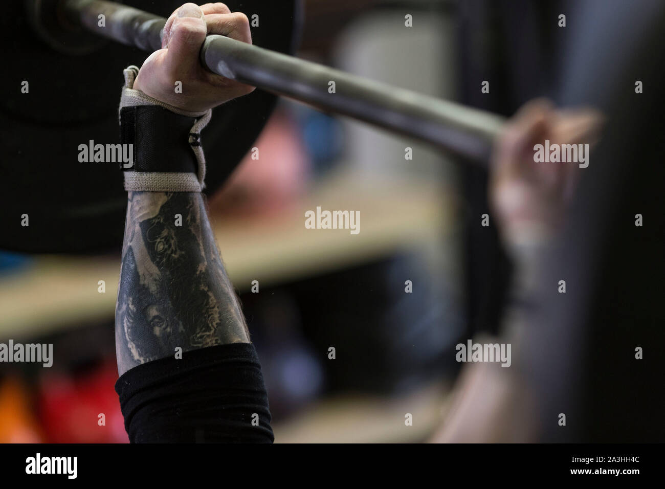 A young white male athlete performs various lifts and bodyweight ...