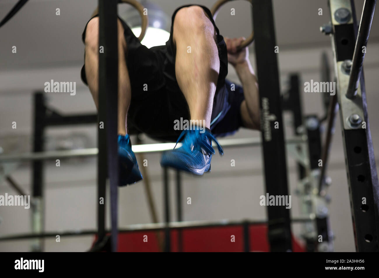 A young white male athlete performs various lifts and bodyweight ...
