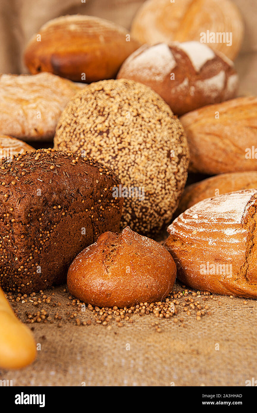 Several types of black and white bread on a burlap background Stock ...