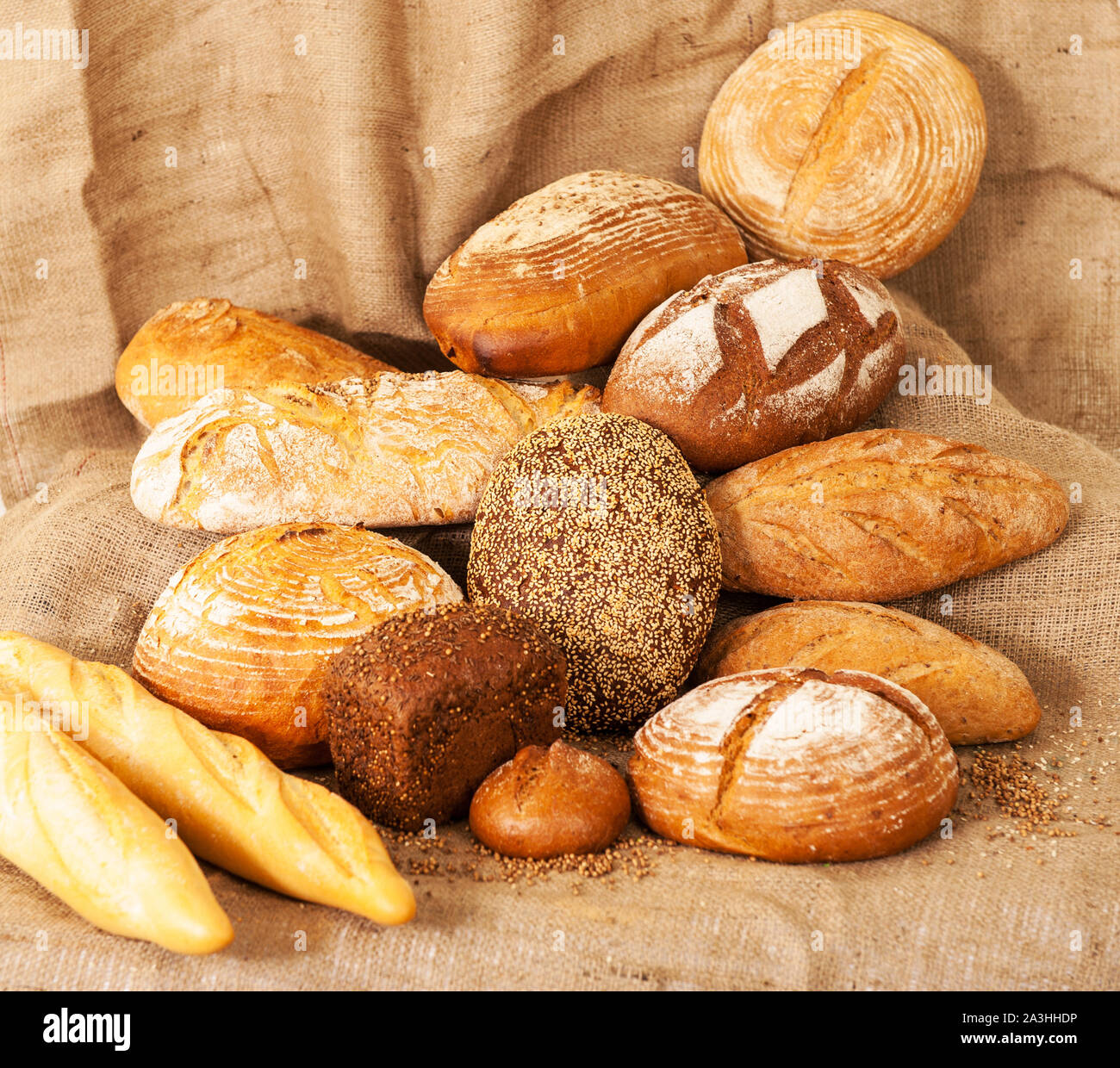 Several types of black and white bread on a burlap background Stock ...