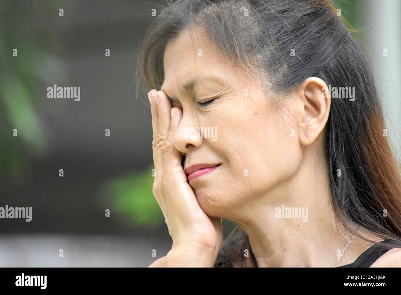 A Sad Senior Asian Person Stock Photo - Alamy