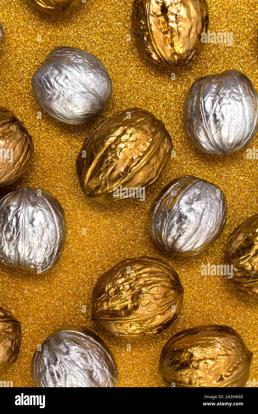Painted golden and silver walnuts on glittering background Stock Photo ...