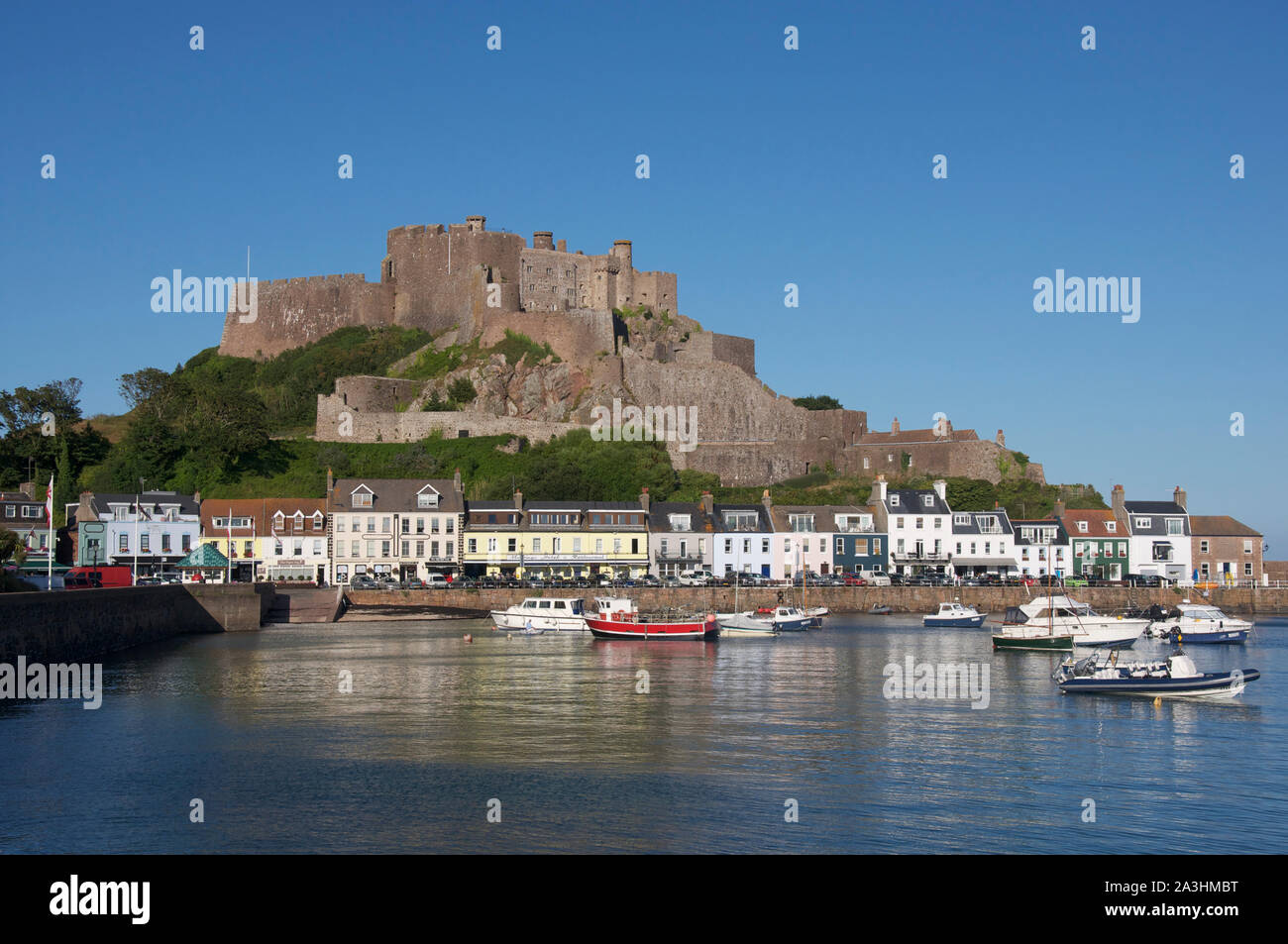 The towering historic medieval stone ramparts of Mont Orgueil Castle ...