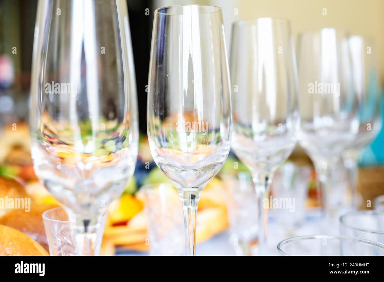 Banquet table served with instruments and decorated with empty wine ...