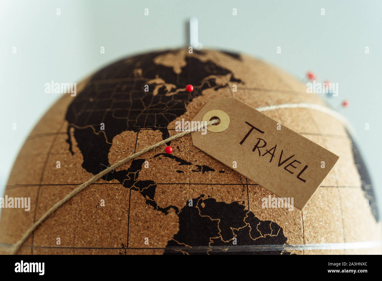 Travel message on a world globe Stock Photo - Alamy