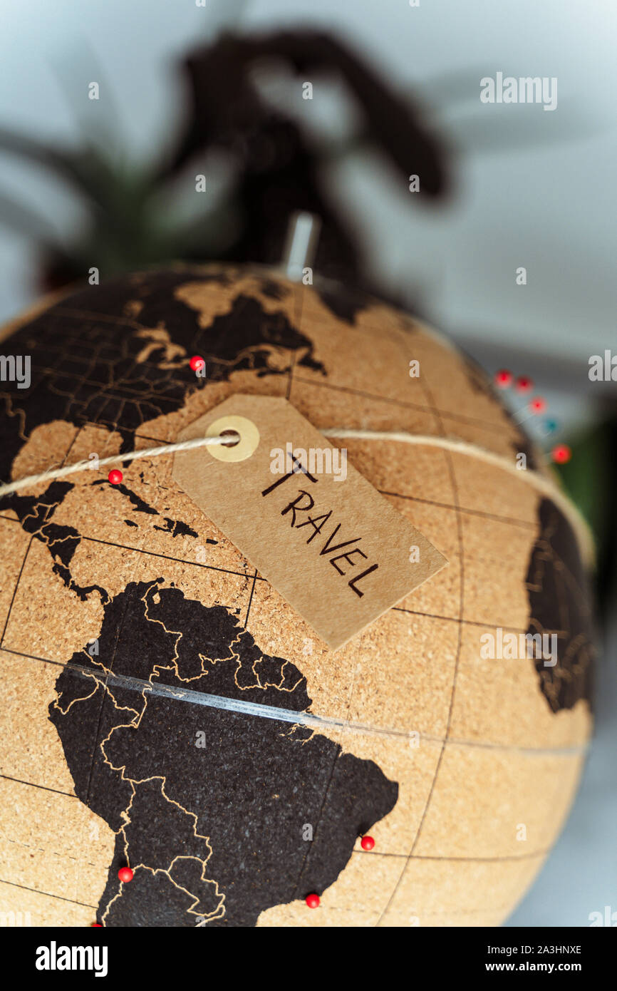 Travel message on a world globe Stock Photo - Alamy