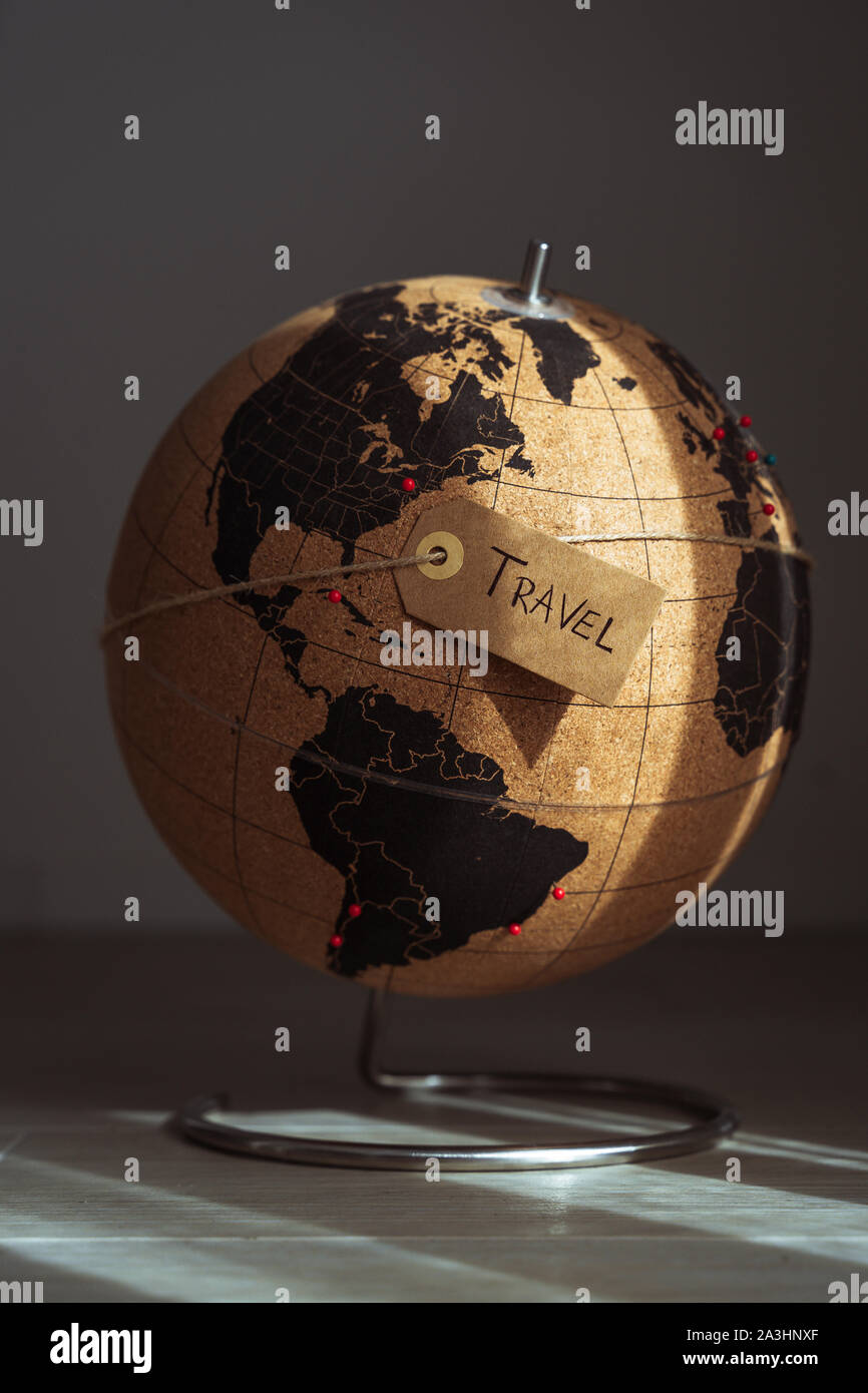 Travel message on a world globe Stock Photo - Alamy