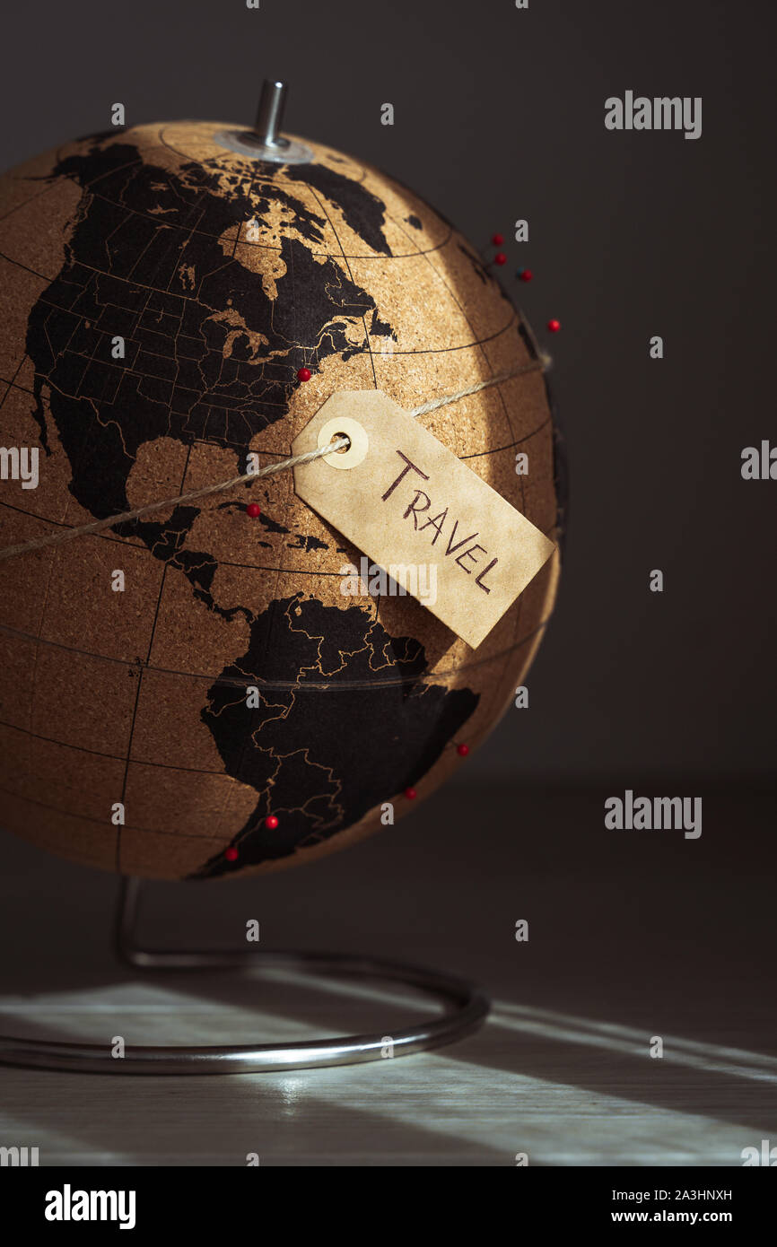 Travel message on a world globe Stock Photo - Alamy