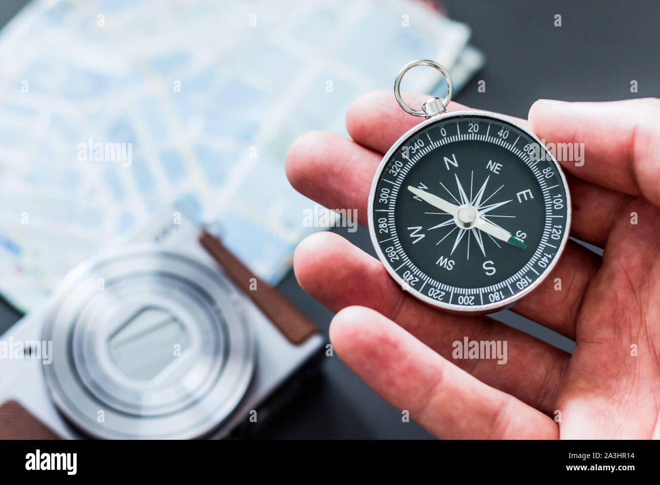 Compass holding in the hand, outdoor adventure Stock Photo - Alamy