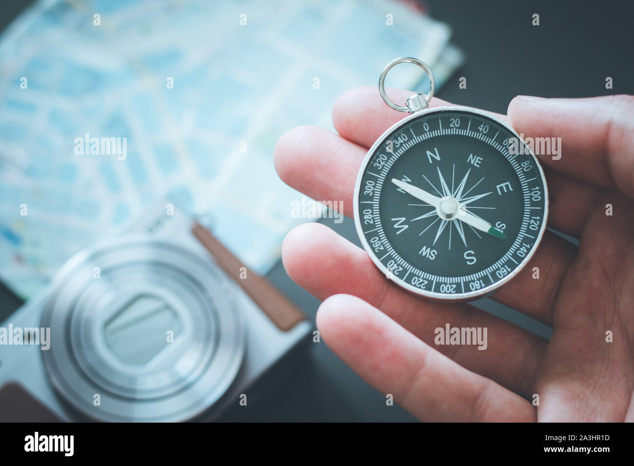 Compass holding in the hand, outdoor adventure Stock Photo - Alamy