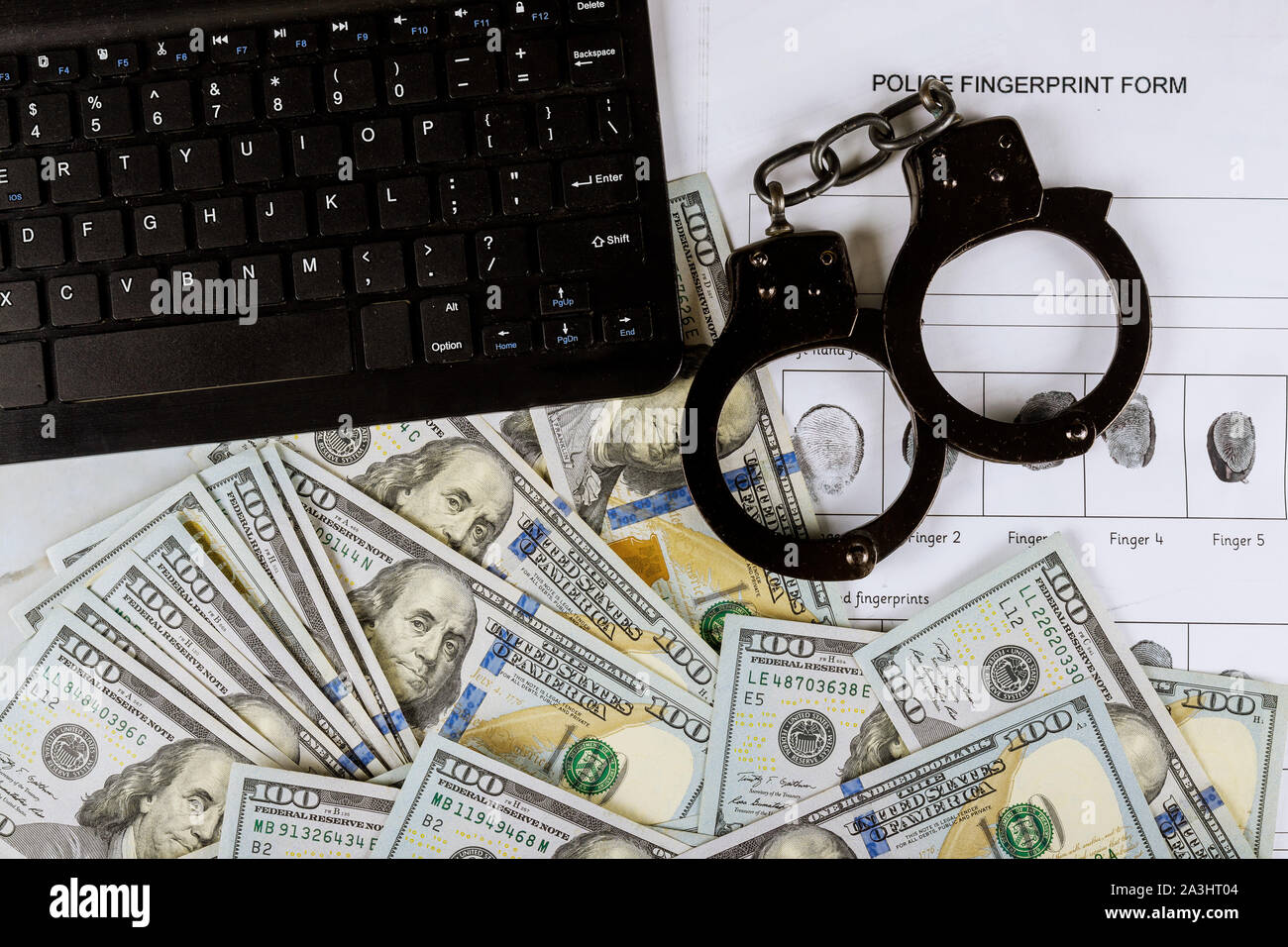 Cyber financial crime with handcuffs on money US hundred dollar bills ...