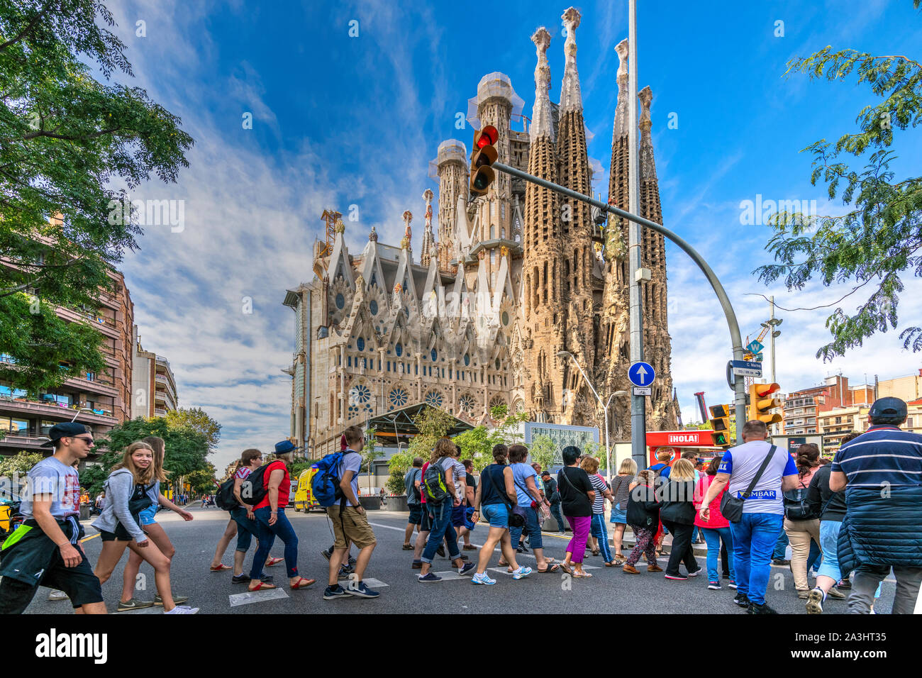Tourists crossing the street to go to visit the Sagrada Familia ...