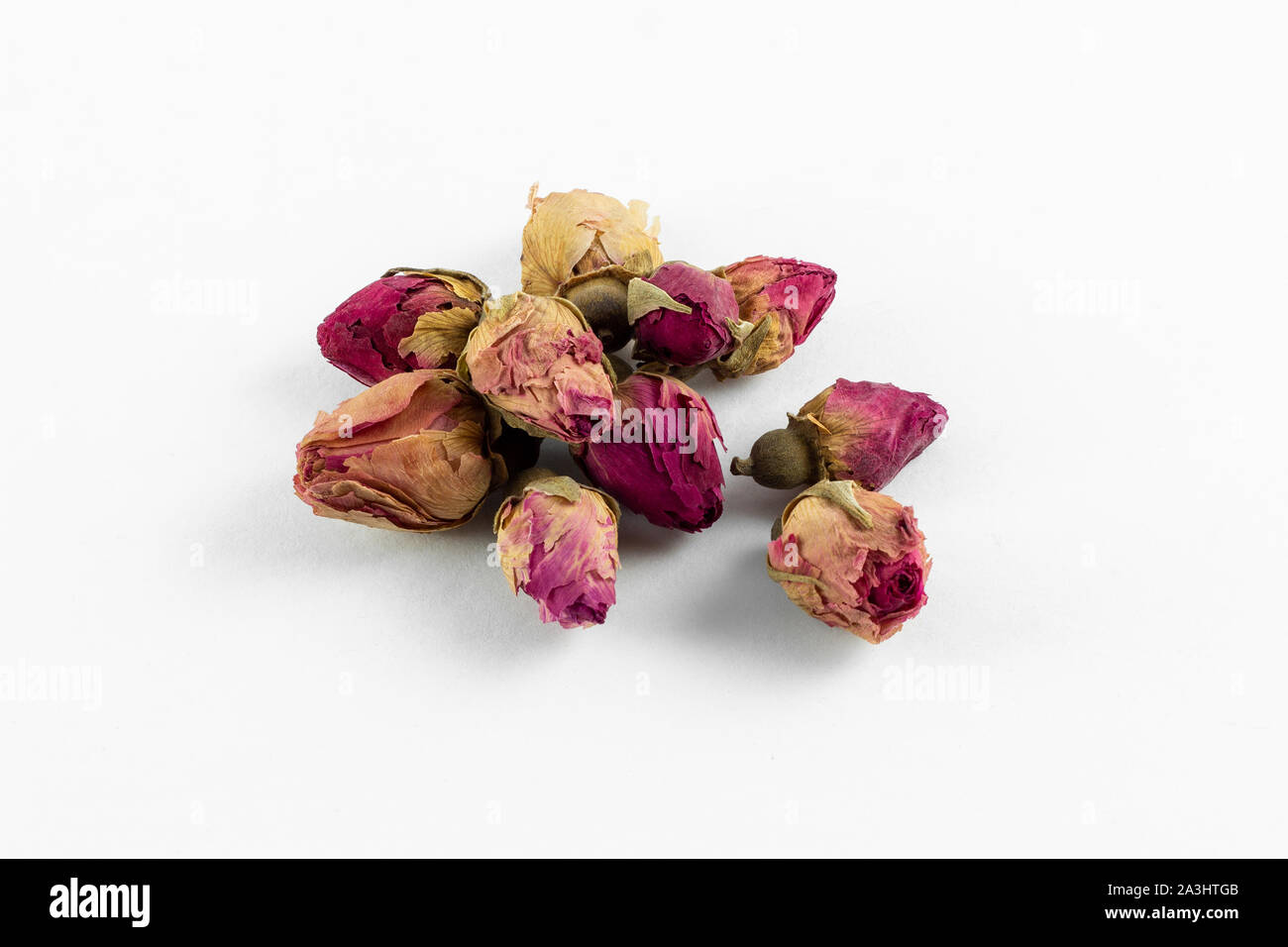 red and pink rose buds tea on white background Stock Photo - Alamy