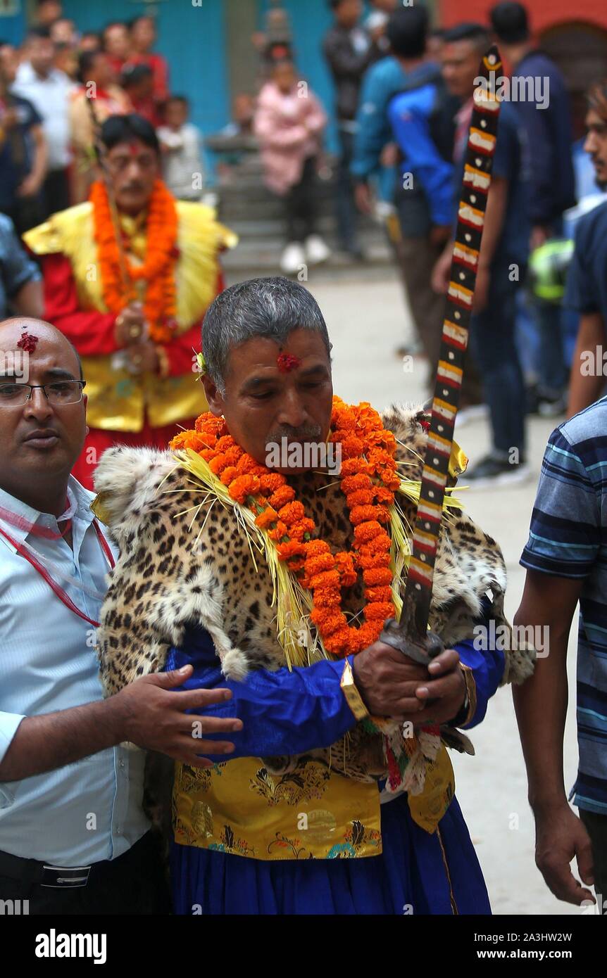 A devotee dressed up as deity carrying sword participates in Khadga ...