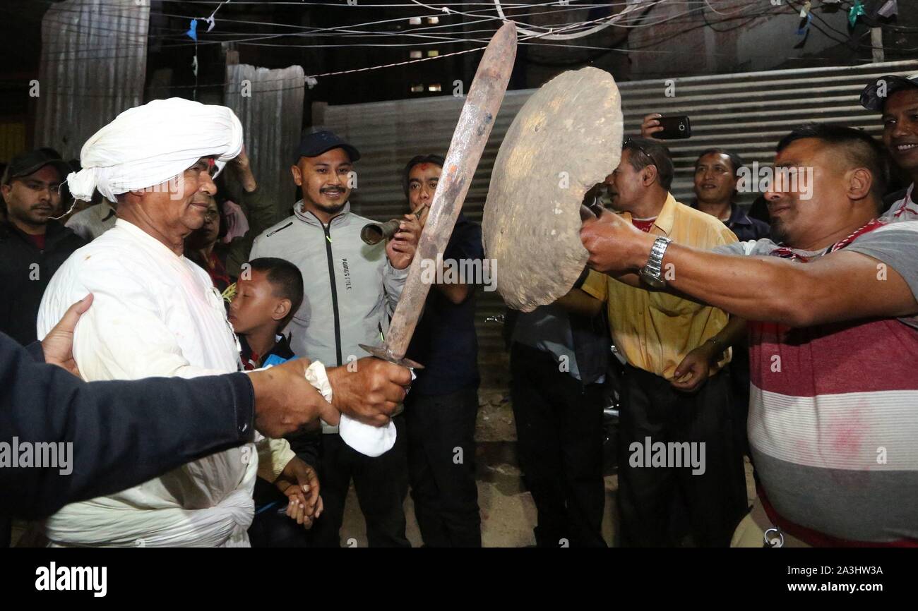 A devotee dressed up as deity hits with sword as he participates in ...