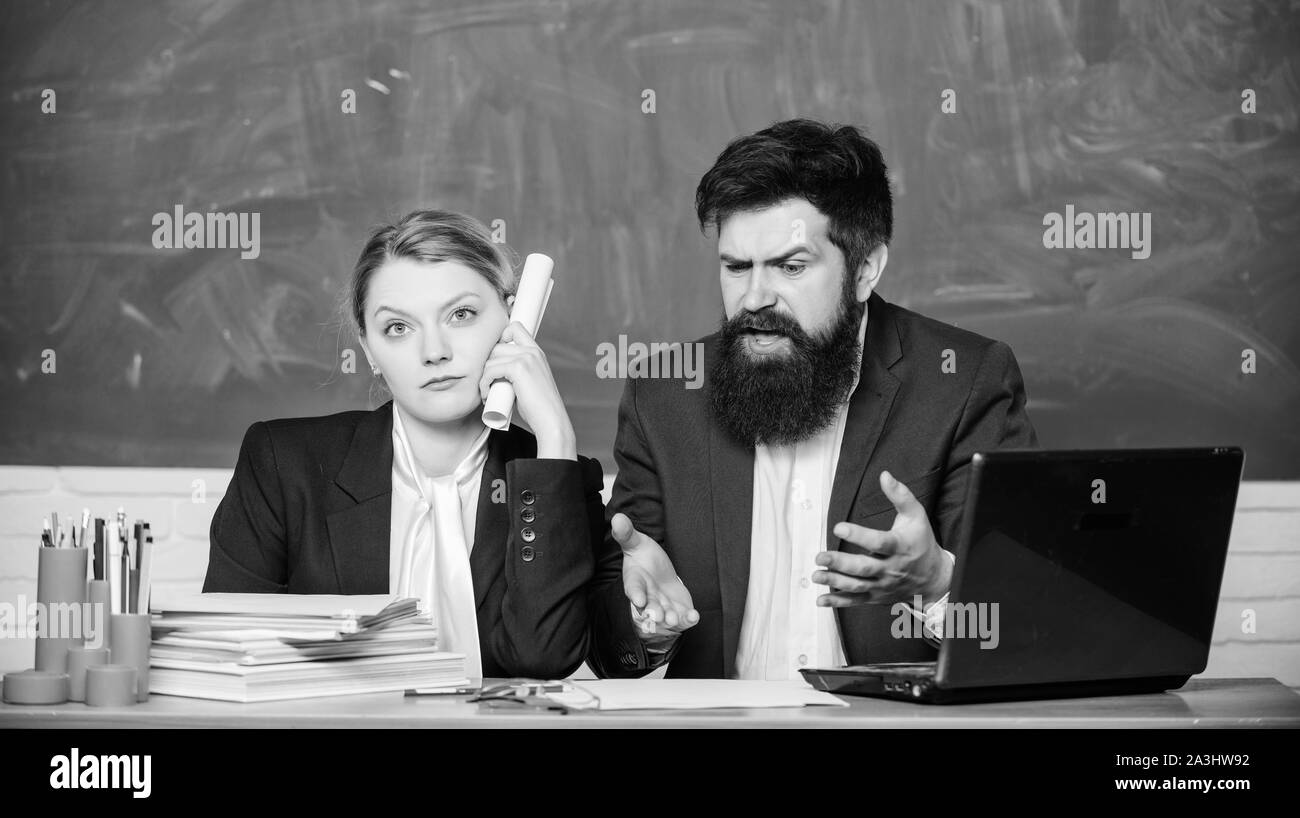 Teacher and supervisor working in school classroom. School educator and ...