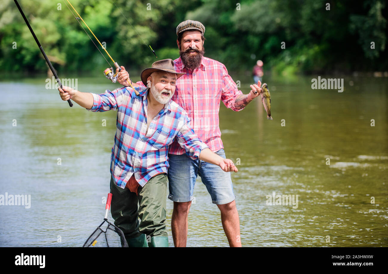 Fishing with spinning reel. Sunny summer day at river. Fisherman family ...