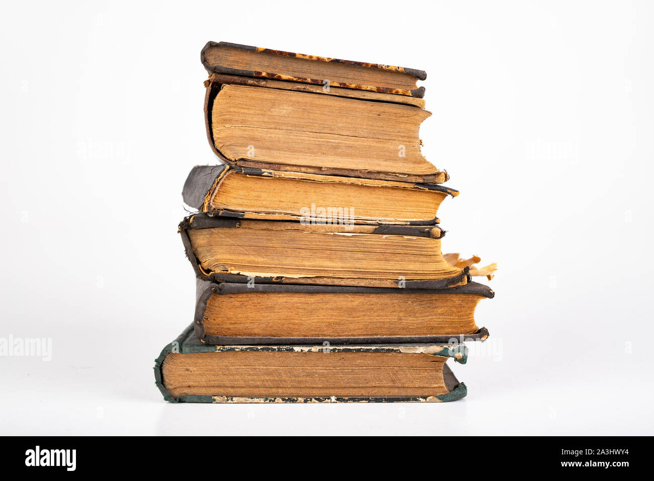 Old dusty books on a light countertop. Library items in old bindings ...