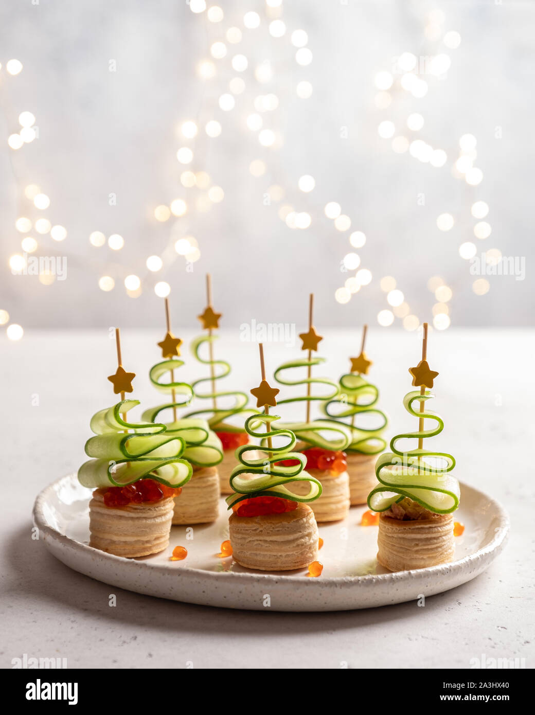 Christmas tree canape with cucumber slice, salmon pate and red caviar ...