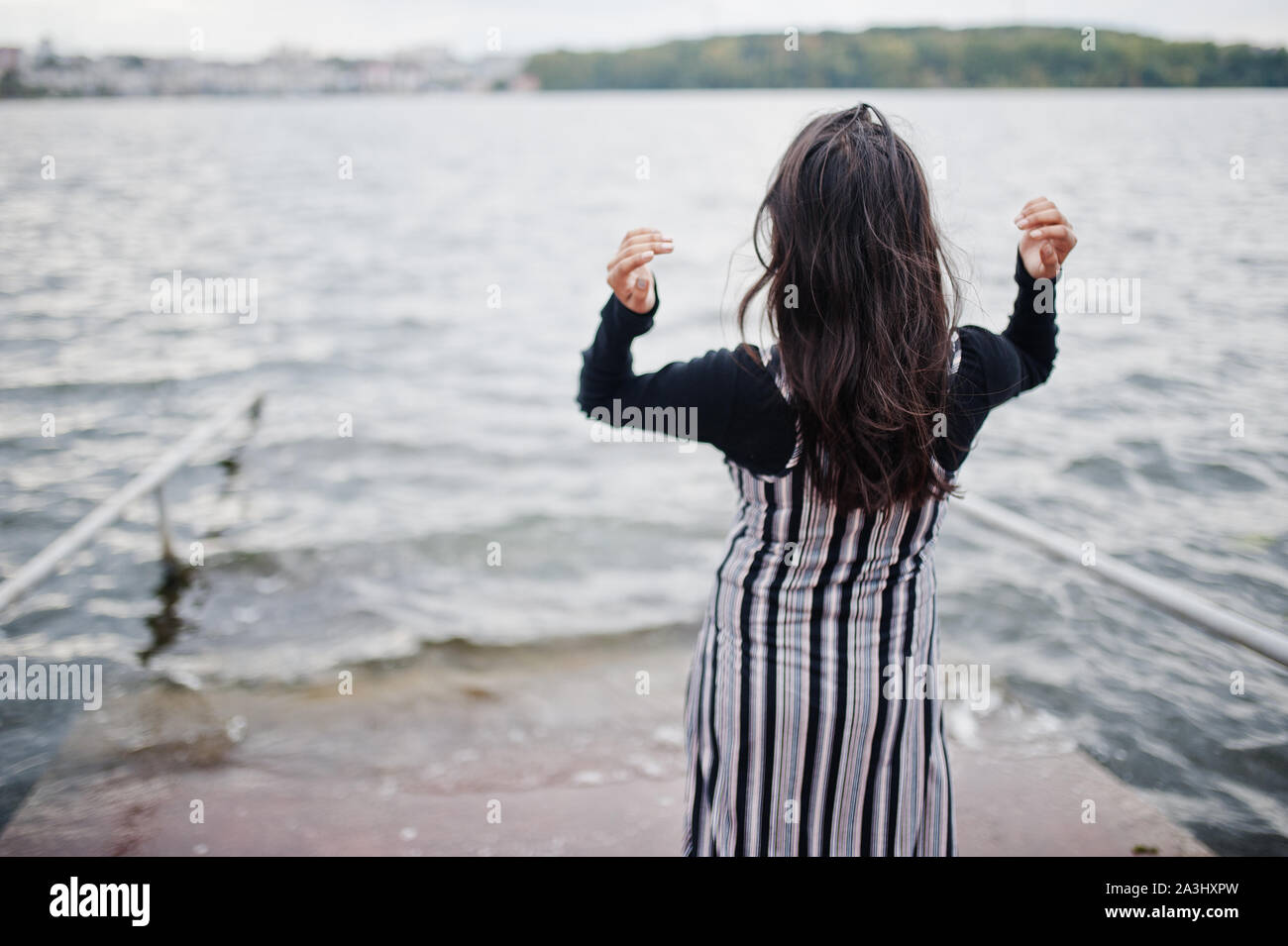 Back of young beautiful indian or south asian teenage girl in dress ...