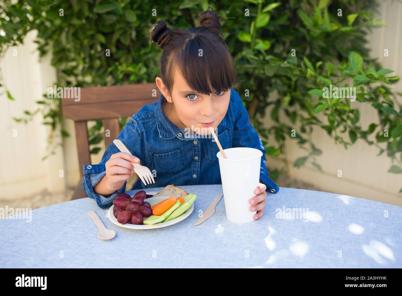 Cute kid Eating Healthy Snacks outdoors With Eco-friendly disposable ...