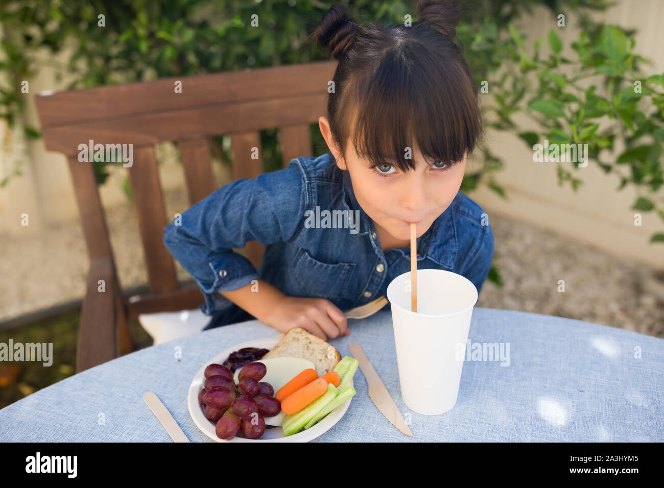 Girl Eating Healthy Outdoors and Using Eco-Friendly Wooden Cutlery ...