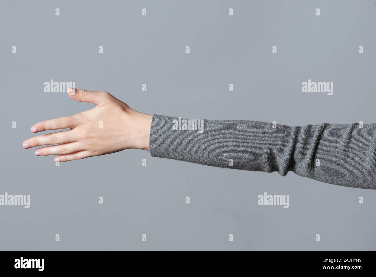 Giving or asking hand sign by female hands isolated on gray background ...