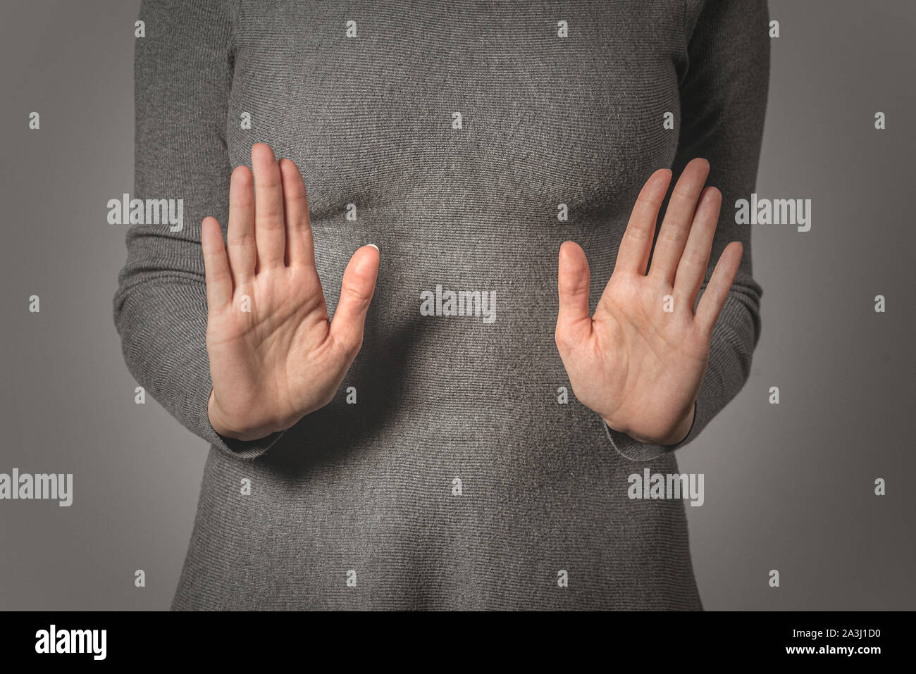 Woman showing a refuse hand gesture sign Stock Photo - Alamy