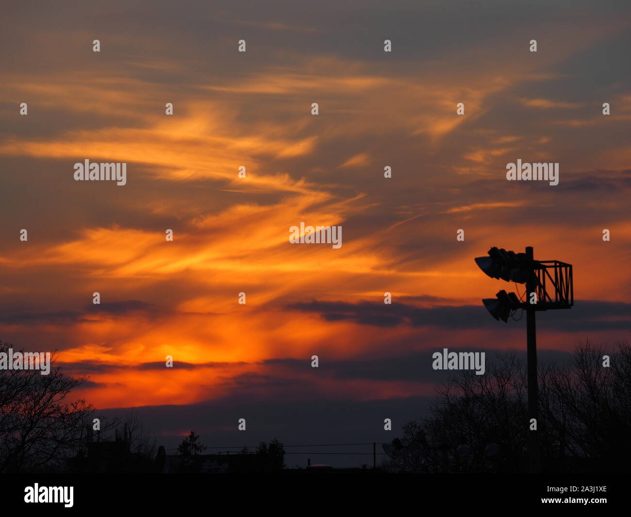Sunset generators – Stadium lights in front of clouds illuminated by ...