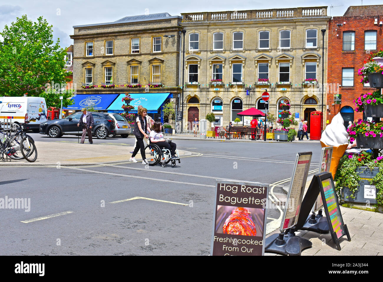 A general street view of the main square in Wimborne. People sitting ...