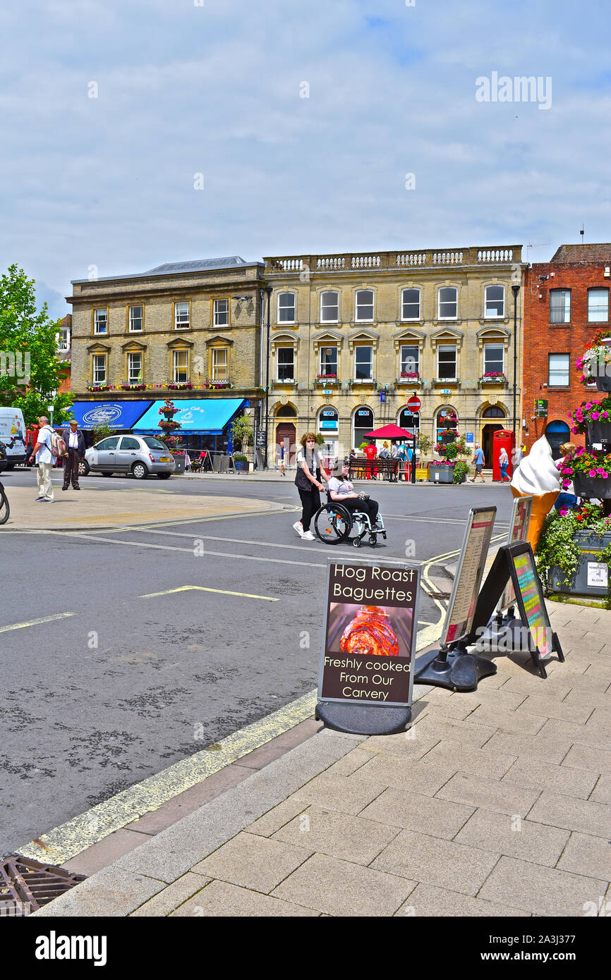 A general street view of the main square in Wimborne. People sitting ...