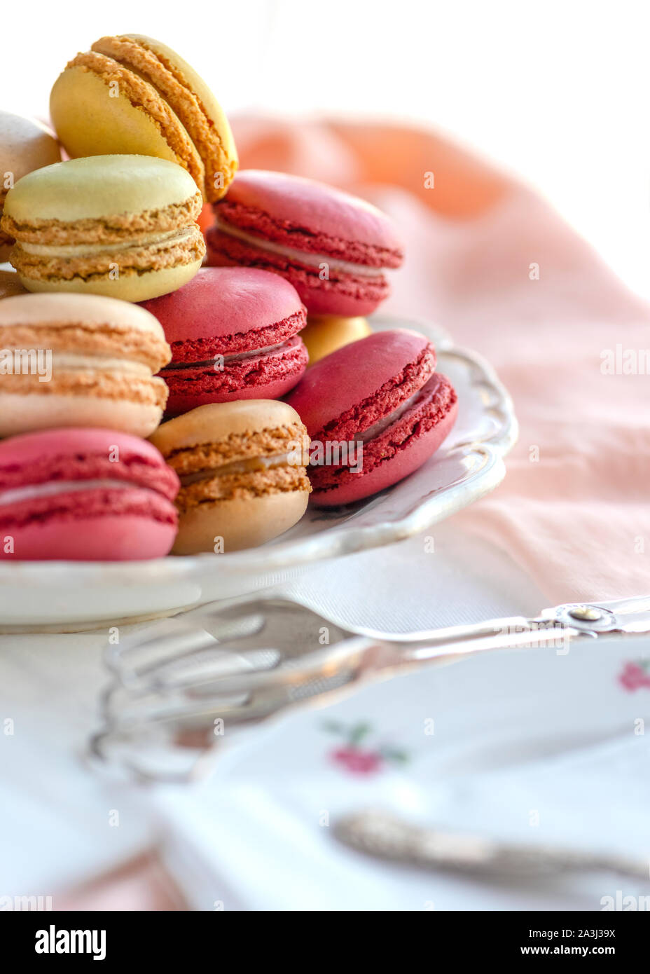 French macarons red yellow and green with silver cutlery Stock Photo ...