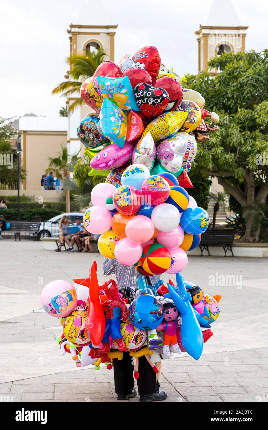 A Mexican vendor sells brightly colored balloons in the Loreto town ...