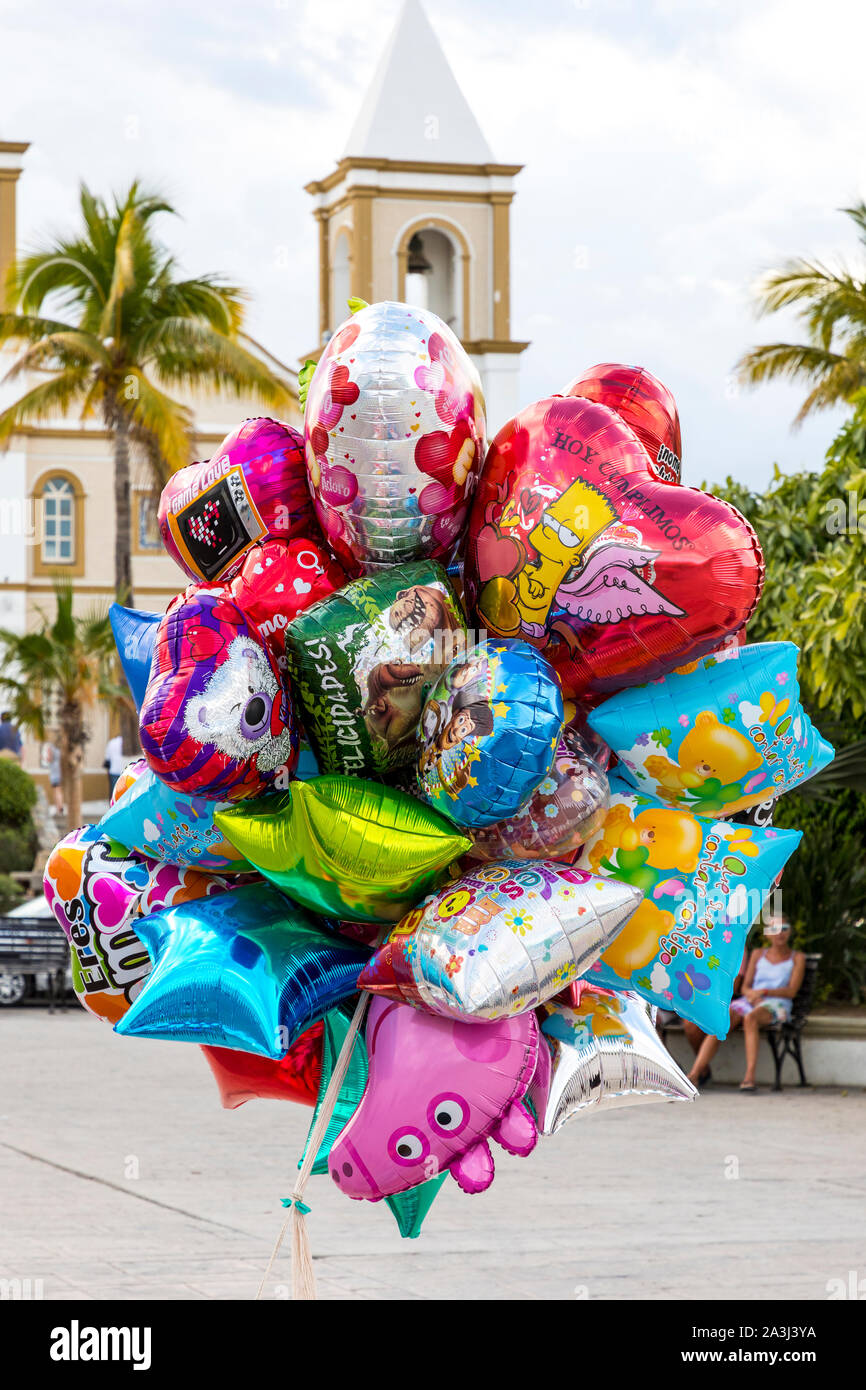 A Mexican vendor sells brightly colored balloons in the Loreto town ...