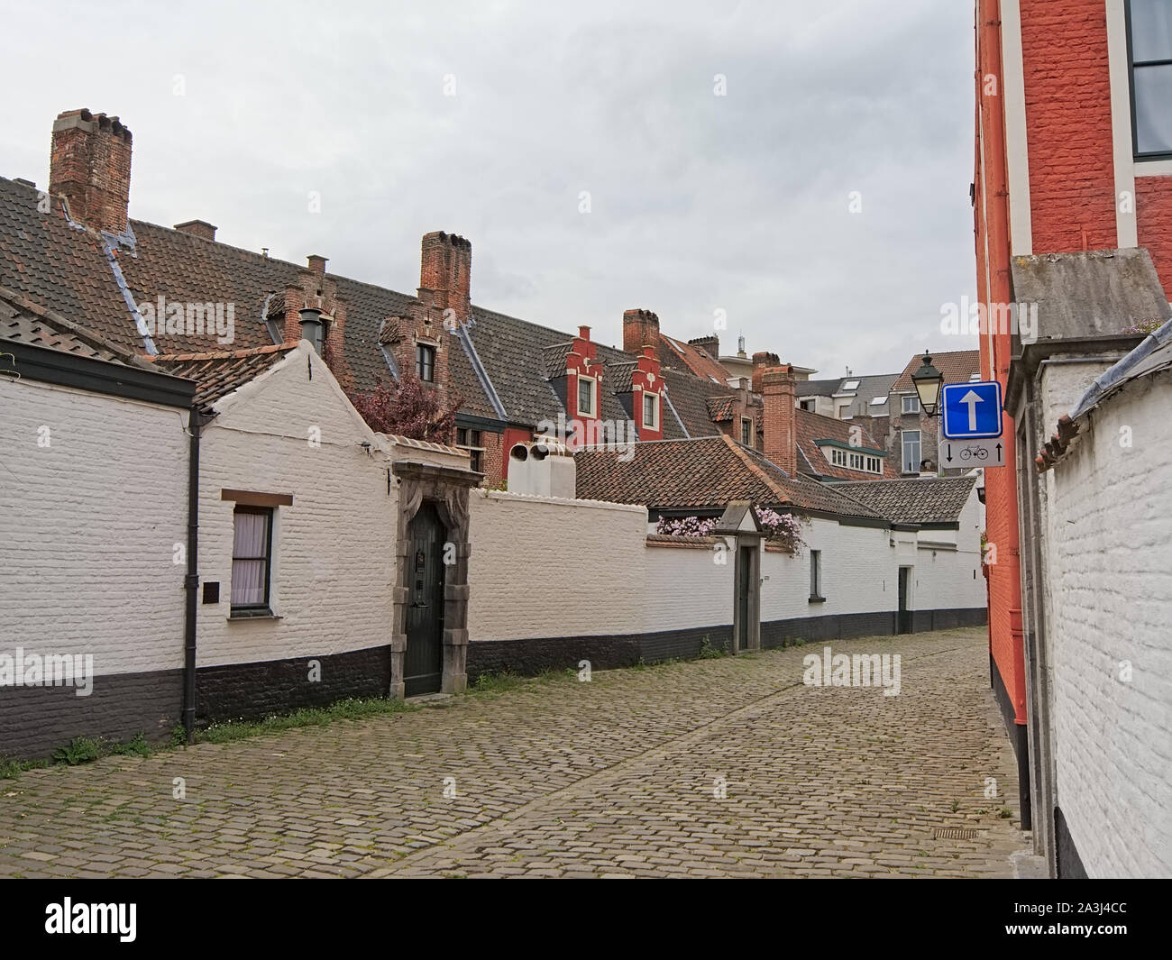 Cobblestone streets with small cosy white painted brick houses of the ...