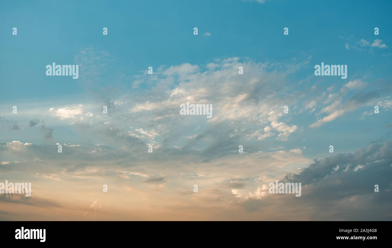 Orange sunset sky background. Soft clouds and blue sky with sunlight ...
