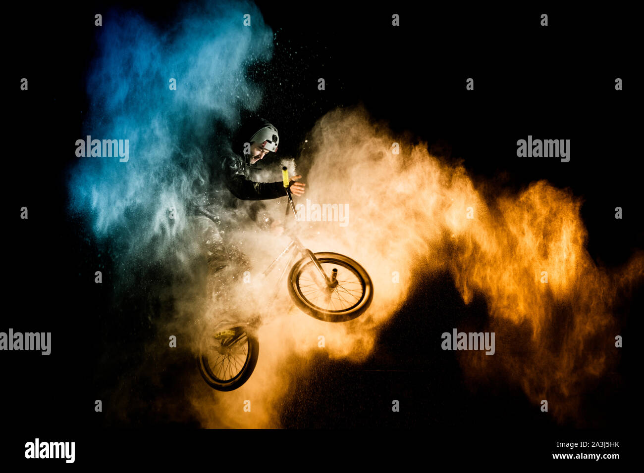 Bike Stunt Acrobatcs with colored Smoke Background Stock Photo - Alamy