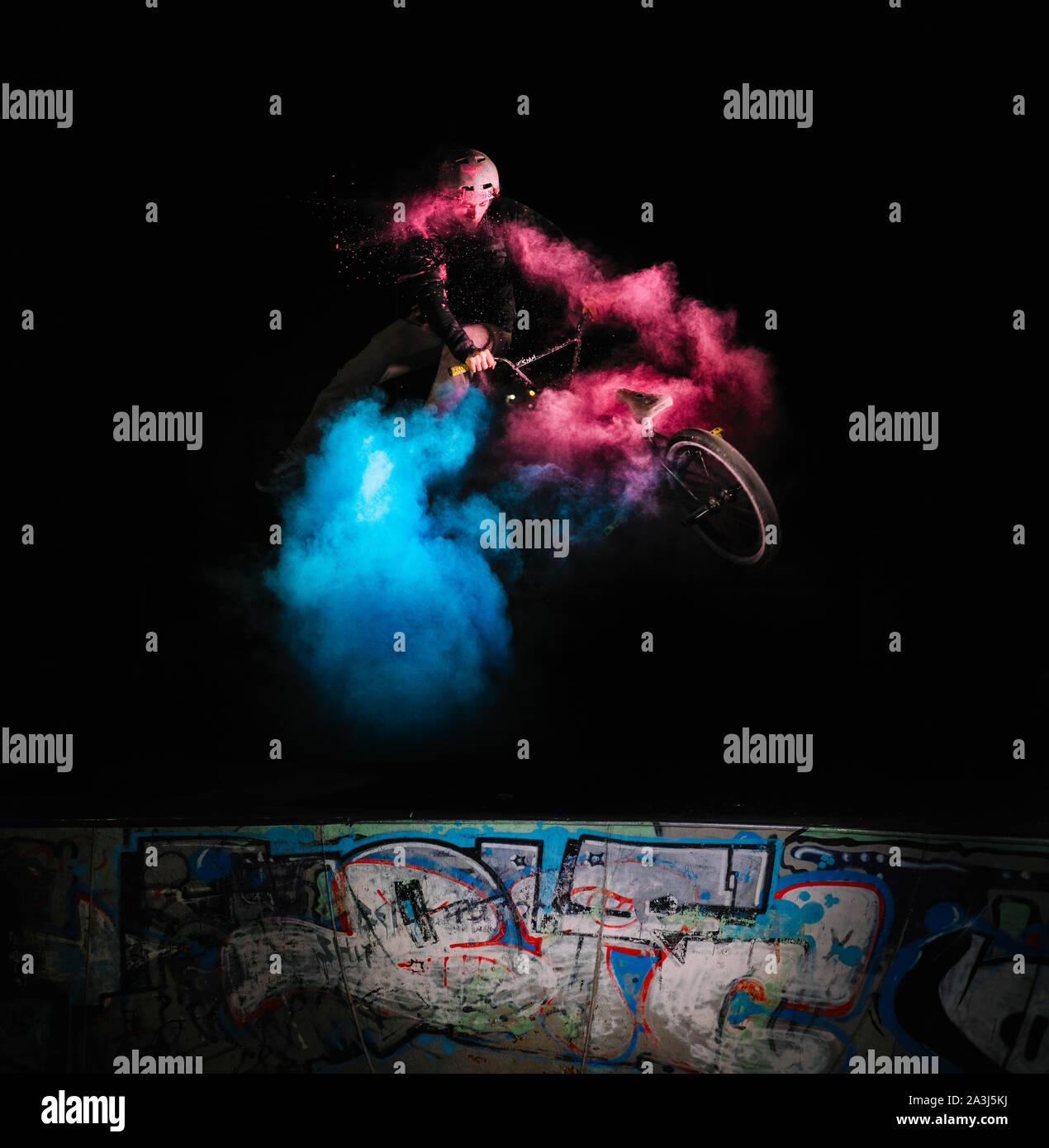 Bike Stunt Acrobatcs with colored Smoke Background Stock Photo - Alamy