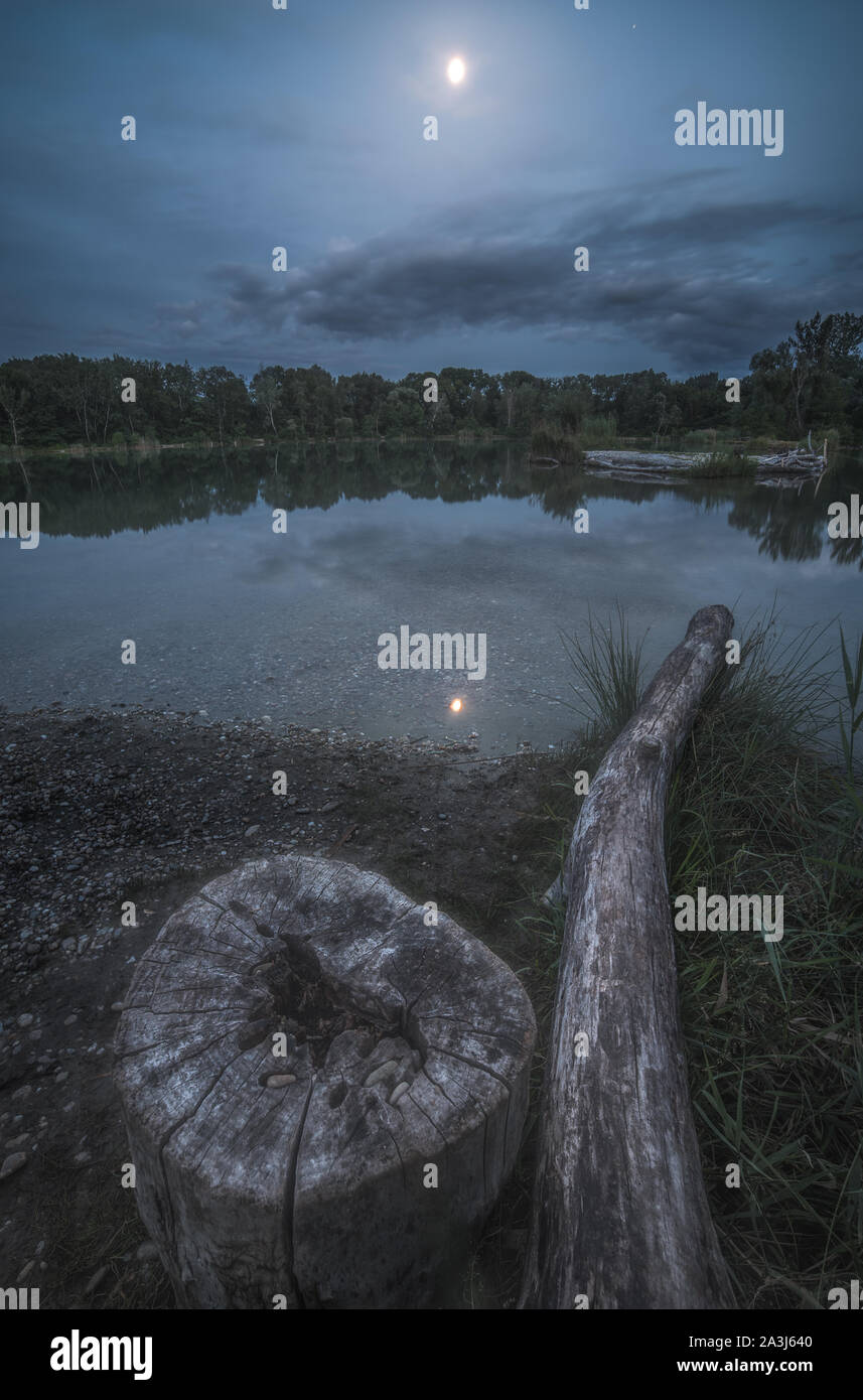 Night Landscape with the Tree Stump by the Lake Lit by the Shining Moon ...