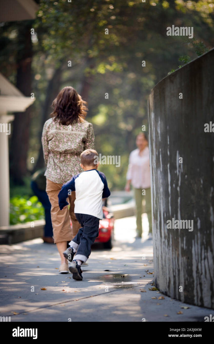 Young boy following his mother on a footpath Stock Photo - Alamy