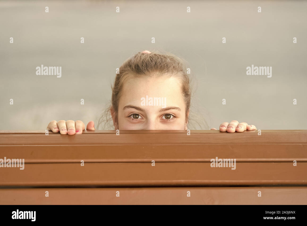 Hide and seek fun. Girl cute smiling kid playful mood. Healthy ...