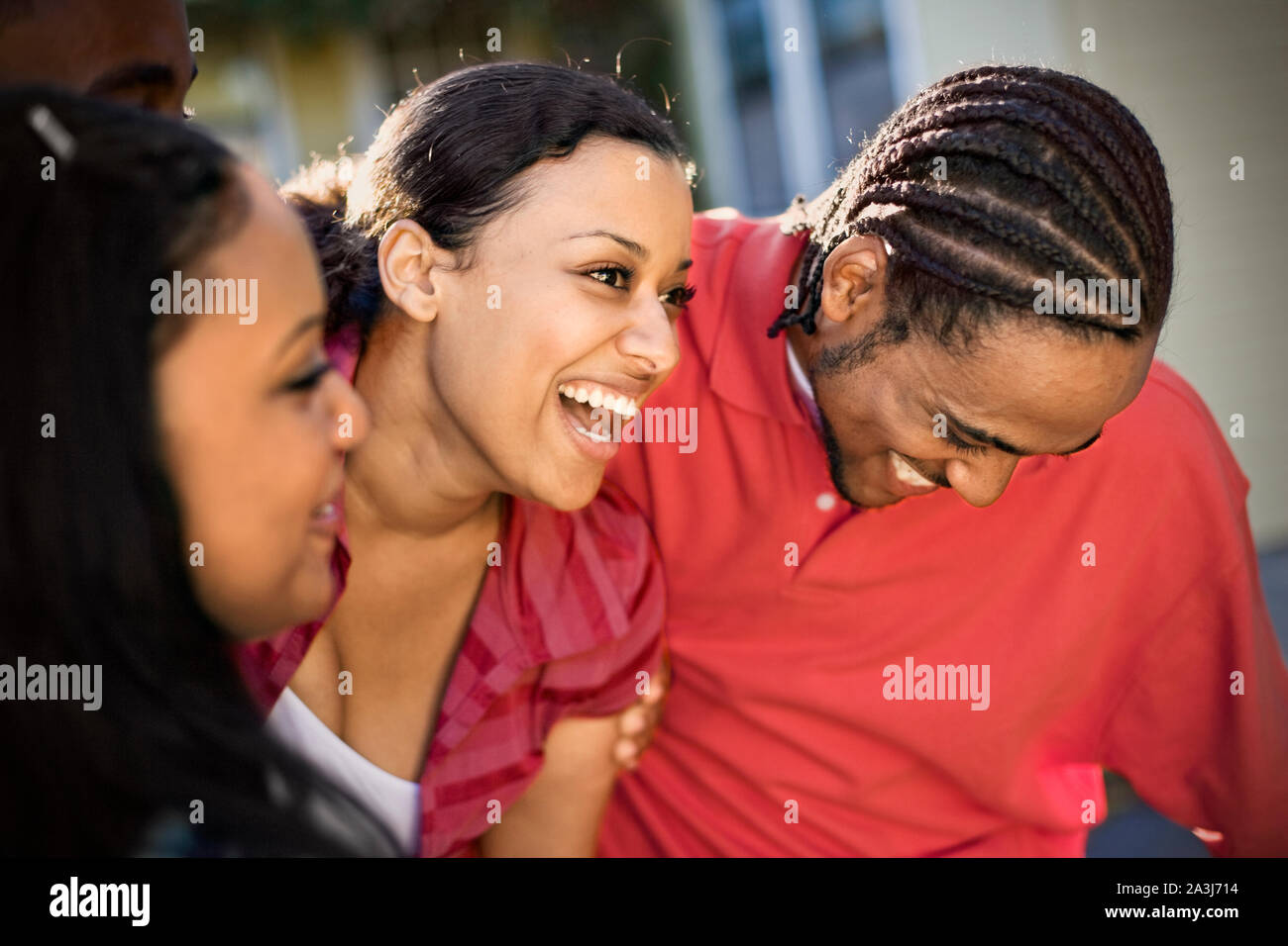 Four friends with their arms around each other Stock Photo - Alamy