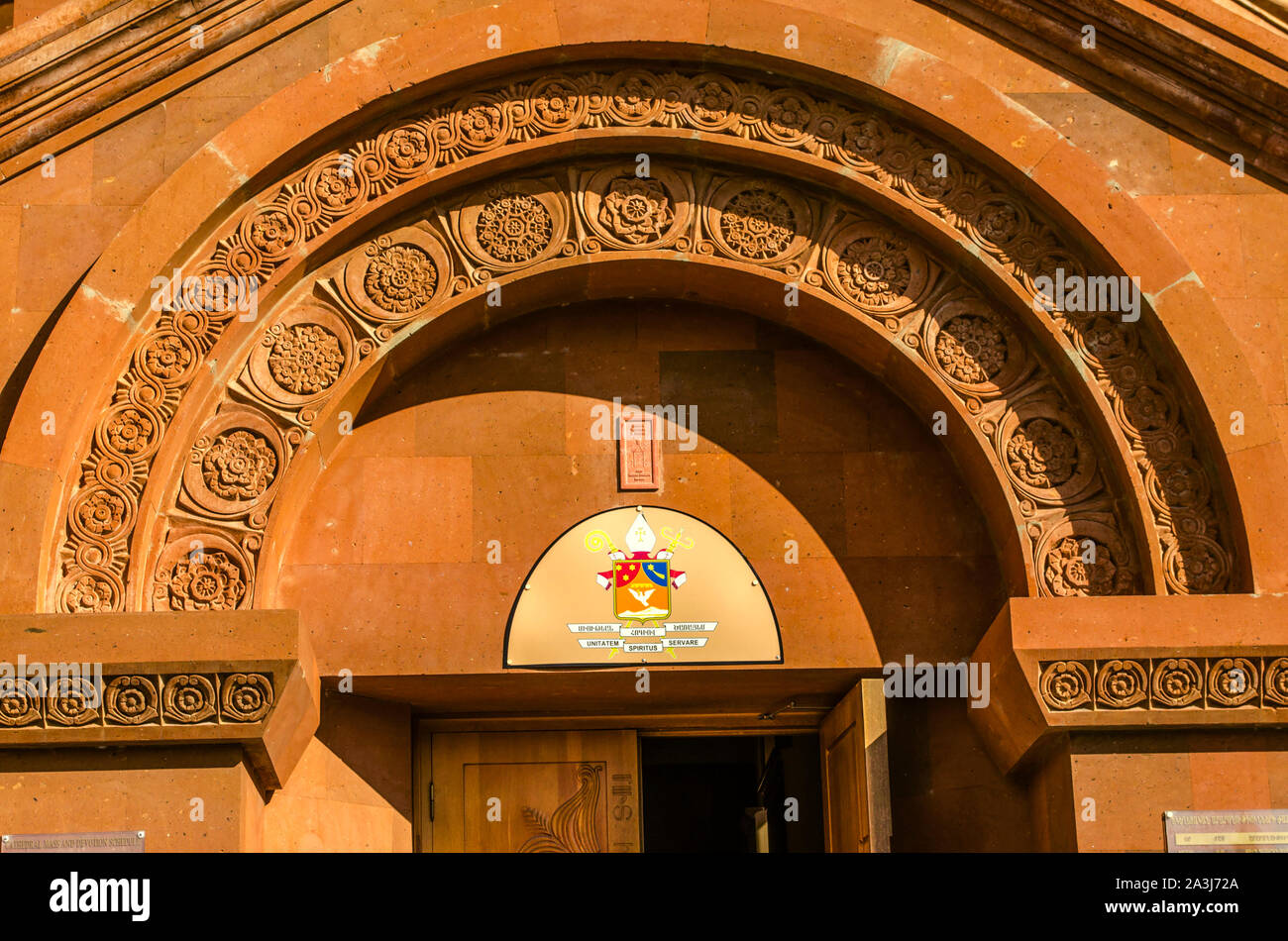 Arched portal with carved ethnic ornament over the doorway of the ...