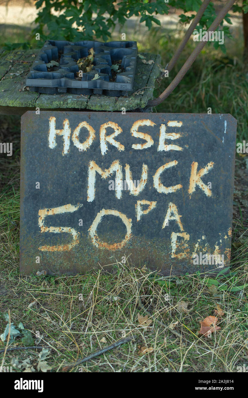 “Horse Muck”, hand painted onto a corroded metal sheet, and left by a ...