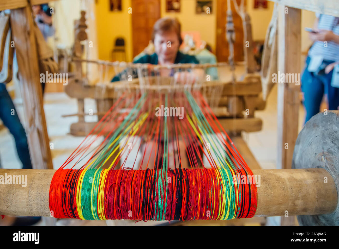 Woman works with traditional hand weaving loom Stock Photo - Alamy