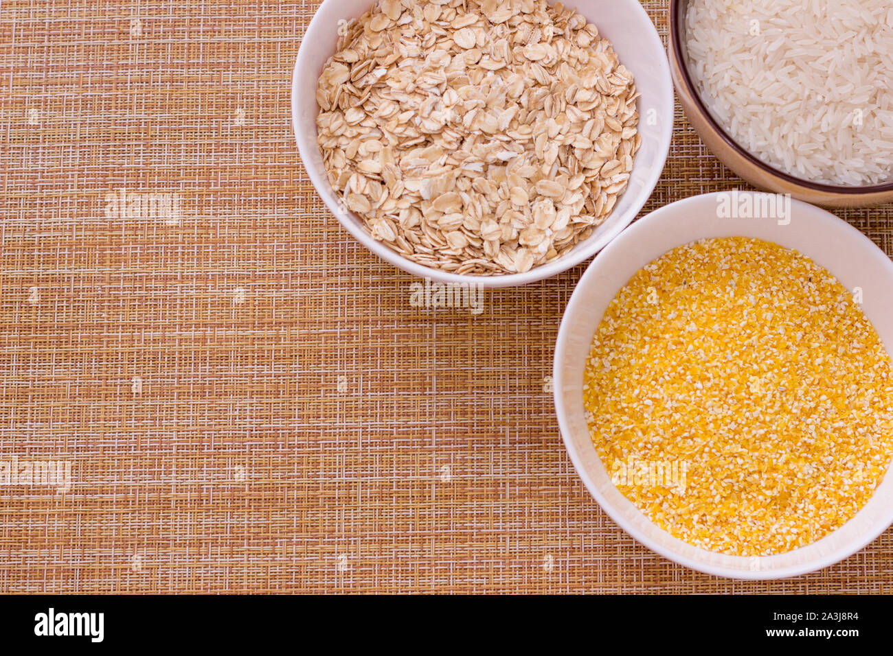 Collection raw cereals, oatmeal, rice, corn on gunny background on top ...