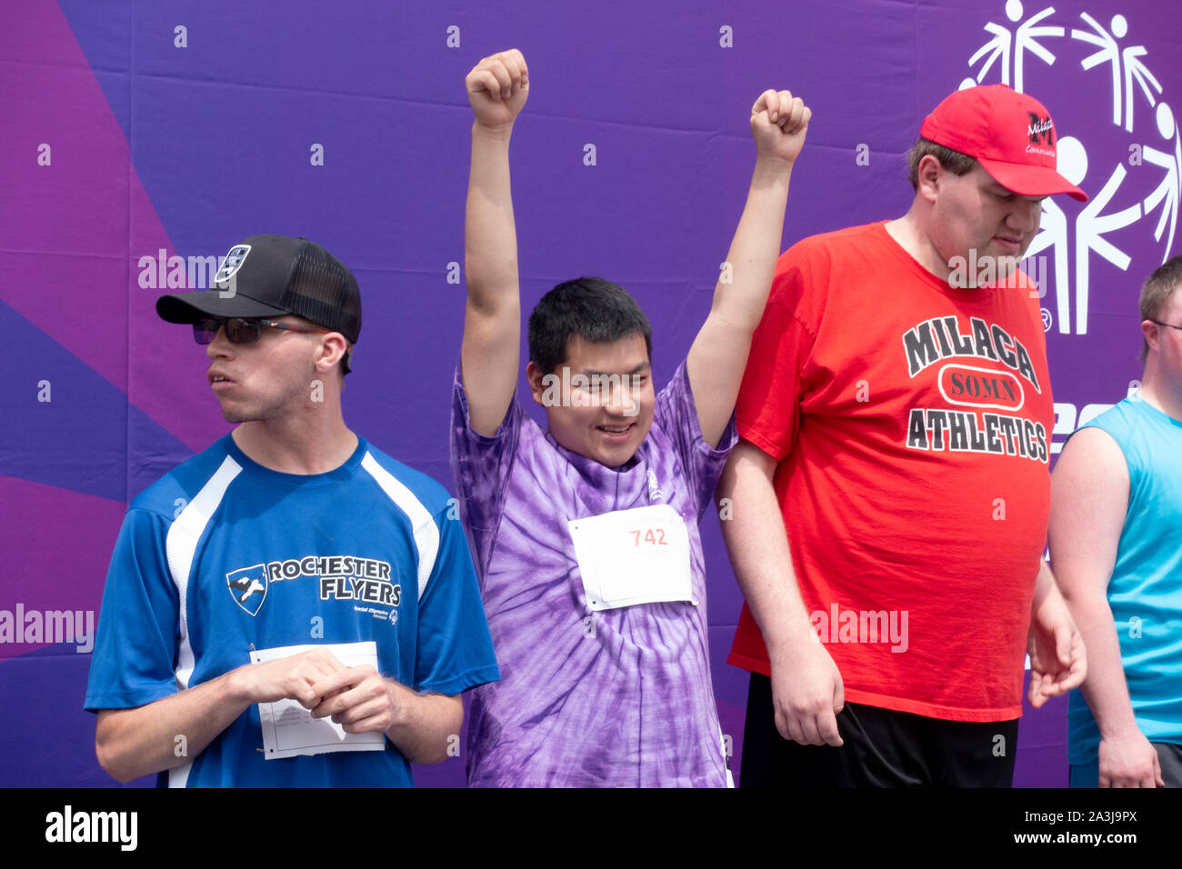 Special Olympic athlete on award podium celebrating his victory. St ...