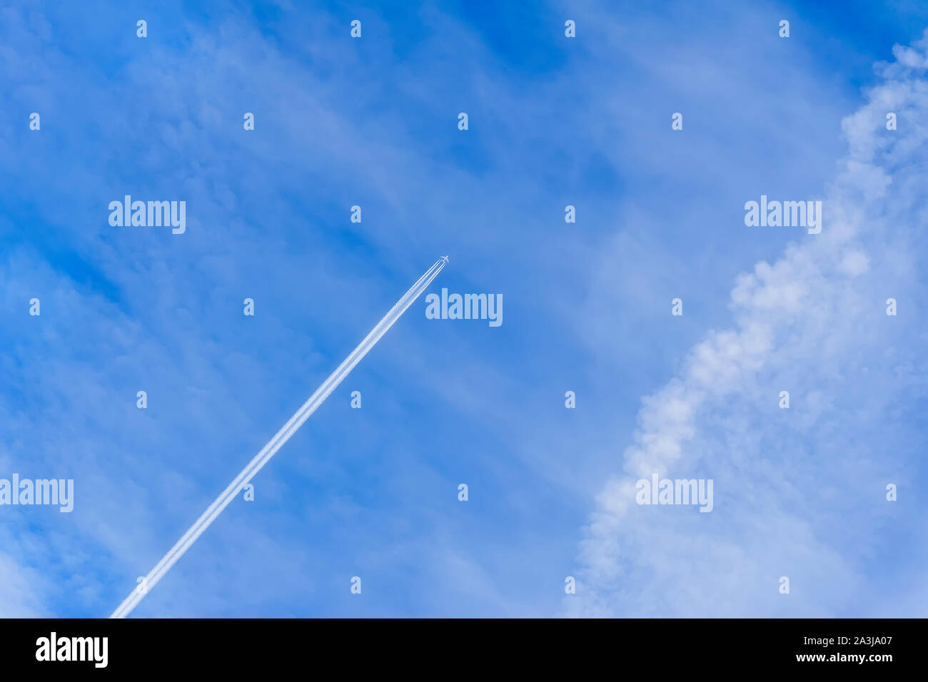 Airplane and trace, condensation trails, vapor trails. Bright blue sky ...