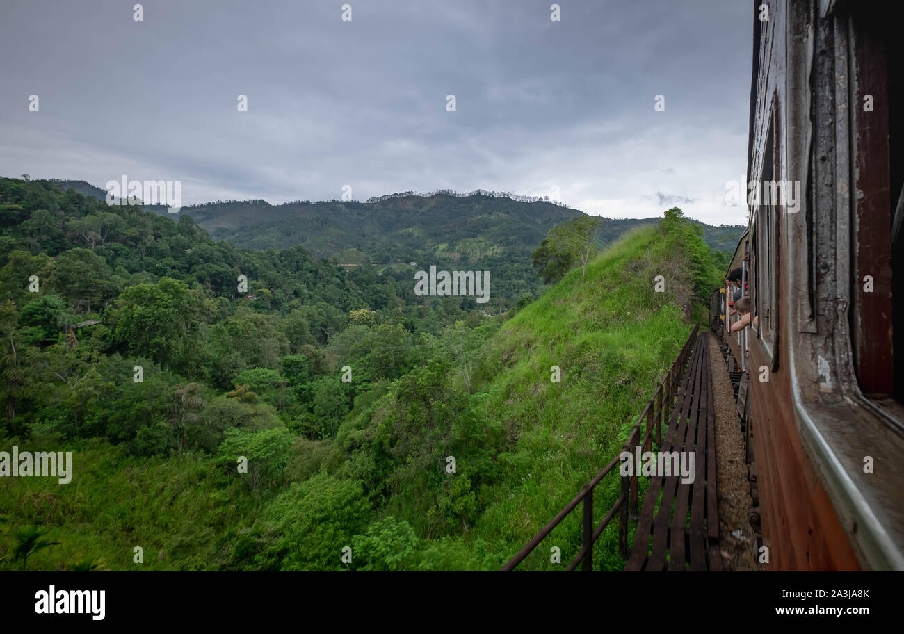 ELLA/ DEMODARA, SRI-LANKA: AUGUST 08/ 2019: The train acrossing the ...